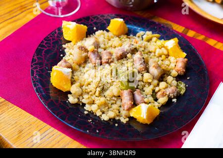 Spanish Migas tropezones from fried flour with bacon, sausage, peppers ...