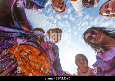 Beautiful shot of friends with colorful faces having fun at the ...