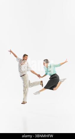 Mid air action pose of energetic female jazz dancer raising leg with ...