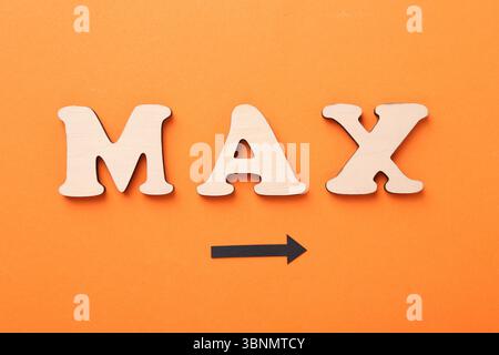 Word Max made of wooden letters and arrow on light blue background ...