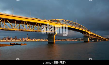 View of the skyline of Auckland behind the Auckland Harbour Bridge ...