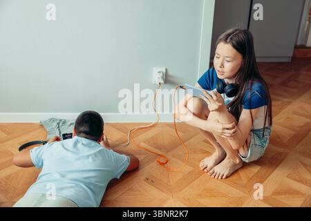 Teen boy with headphones using tablet on isolated background Stock ...