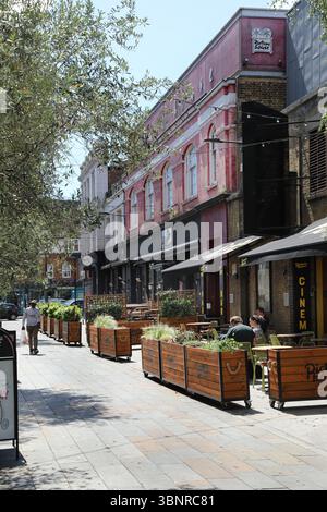 Clapham, London, UK. Outdoor restaurant tables in Venn Street, a ...