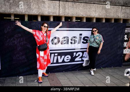 Oasis fans pose for pictures outside the Principality Stadium, Cardiff ...