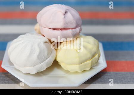 On the table and on a white saucer lie ripe apricots Stock Photo - Alamy