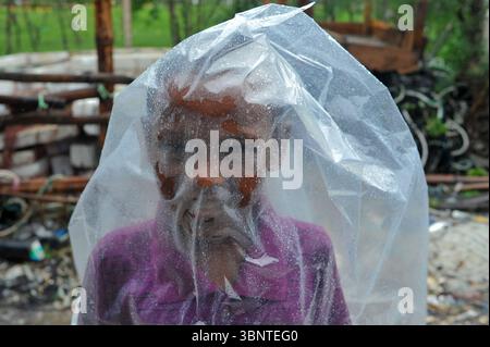 A child shields themselves from the storm using plastic as Cyclone ...