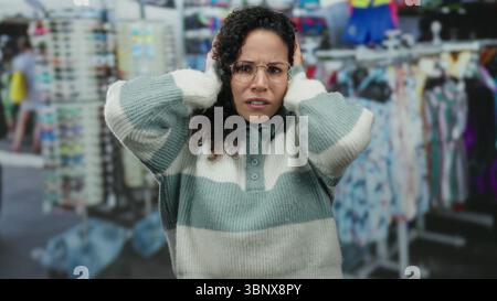 Woman in sweater feeling overwhelmed in busy street market with ...