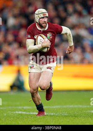 Mack Hansen of the British & Irish Lions passes the ball as he is ...