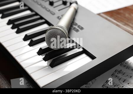 Sheets of music and professional microphone on table, closeup Stock ...