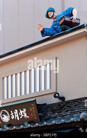 Asakusa, Tokyo, Japan - A statue of a man wearing traditional Japanese ...