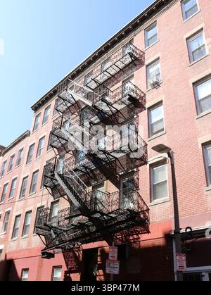 A photograph of red-brick tenement buildings in Boston, Massachusetts ...