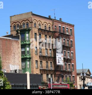 A photograph of red-brick tenement buildings in Boston, Massachusetts ...