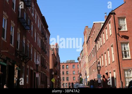 A photograph of red-brick tenement buildings in Boston, Massachusetts ...