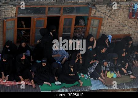 Kashmiri Shiite Muslim women watch a Muharram procession in Srinagar ...
