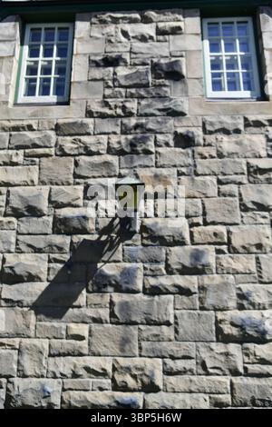 Stonework with imbedded windows and artifacts making a textured design ...