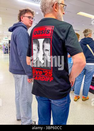 Oasis fans wearing Liam and Noel Gallagher masks pose for a photo ...