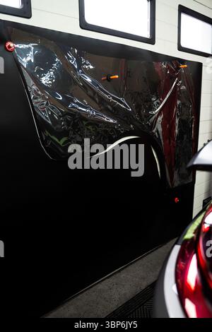 Vinyl wrap is manually cut using stencil over the film for precise ...