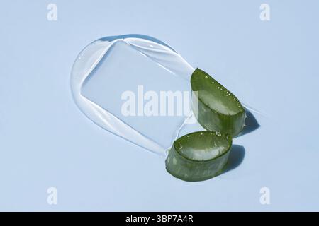 Aloe vera soothing gel smear texture on blue background. Skin care ...