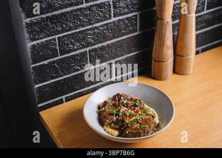 Traditional german braised veal cheeks in brown sauce with mashed ...