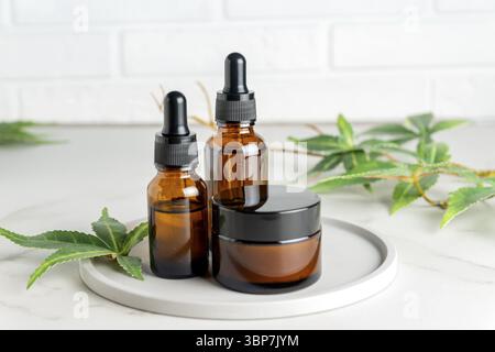 Hemp cbd oil serum in glass dropper bottles with cannabis leaves ...
