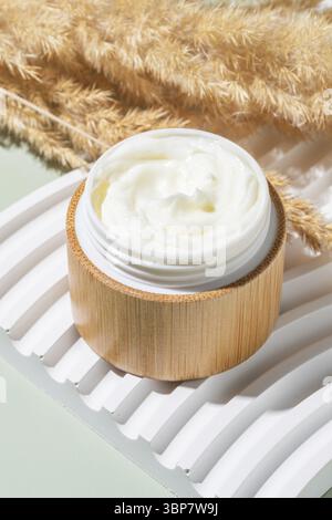 Cosmetic skin care products with pampas on pastel beige background ...