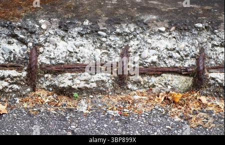 Exposed rusty rebar in crumbling concrete shows urban decay gritty ...