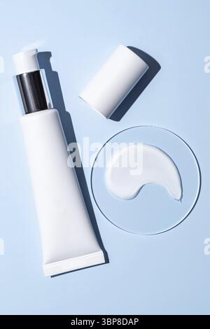 Pomp tube of face or hand cream and sample texture in petri dish on ...