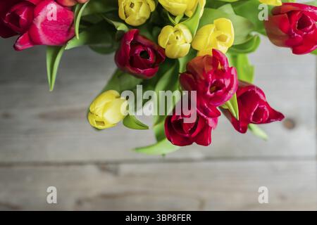 Top view of bouquet of red and yelow tulips . Floral background ...