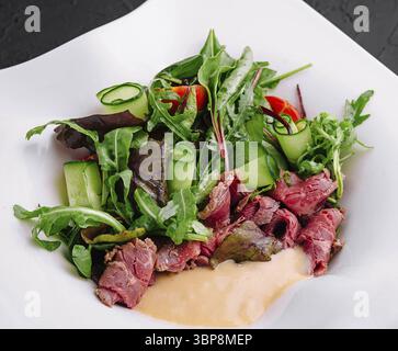 Plate with tasty tomato carpaccio on dark wooden background Stock Photo ...