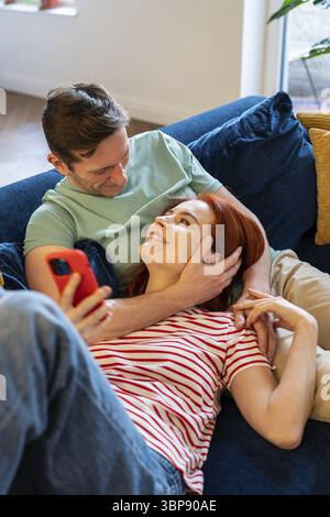 Male and his life partner resting in bedroom Stock Photo - Alamy