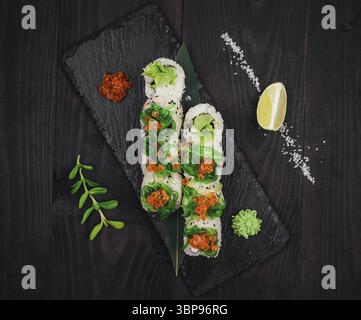 Hot sushi rolls on a wooden board with soy sauce and wasabi Stock Photo ...