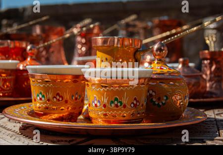 Traditional Turkish copper bowl with a shiny gold finish, reflecting ...