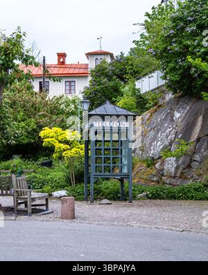 A vintage telephone booth in Vaxholm island with the word TELEFON ...