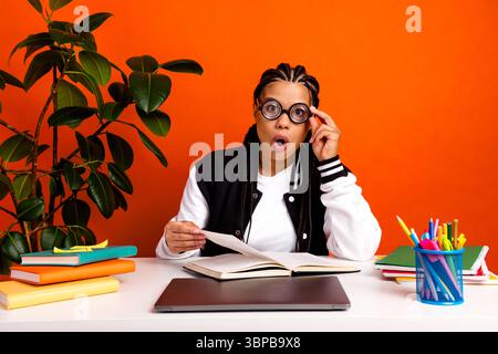 Amazed teenager. Schoolgirl in school uniform hold mathematics measure ...