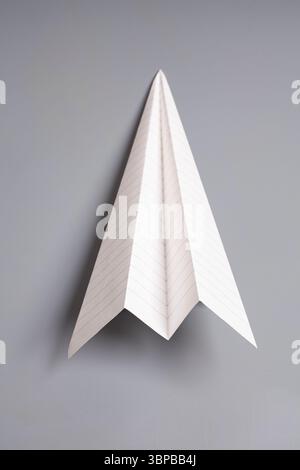 Origami paper airplane on gray background Stock Photo - Alamy