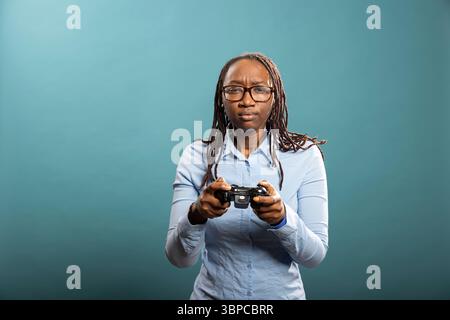 Pretty woman gamepad in hands playing games entertainment consoles to ...