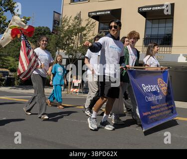 Orinda 4th of July Parade: Young women walk down the street leading a ...