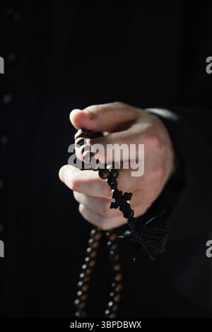 Male praying priest with rosary beads, closeup Stock Photo - Alamy