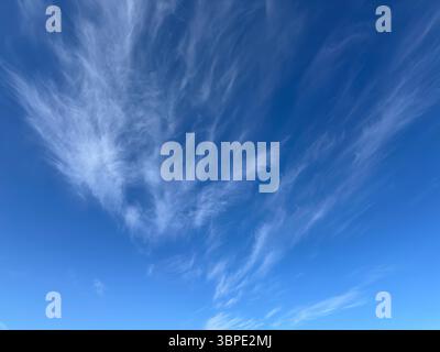 Clouds drift across sky as sun sets, casting warm glow over tranquil ...