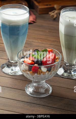 Colorful matcha lattes with dessert and berries Stock Photo - Alamy