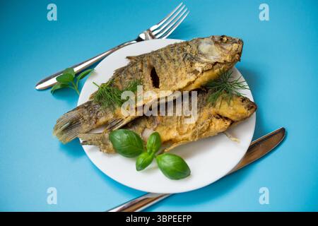 Traditional Ukrainian fried crucian carp in a village kitchen Stock ...