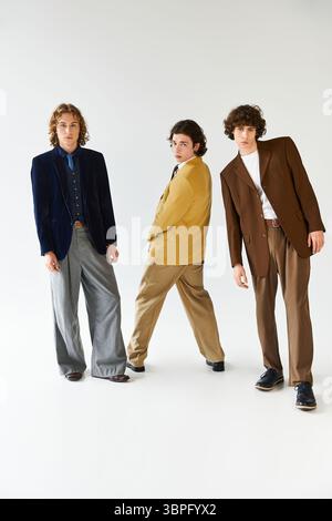 Three young men showcase trendy outfits and playful camaraderie while ...