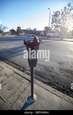Fallen trees and damaged homes line a street Tuesday, April 14, 2020 ...