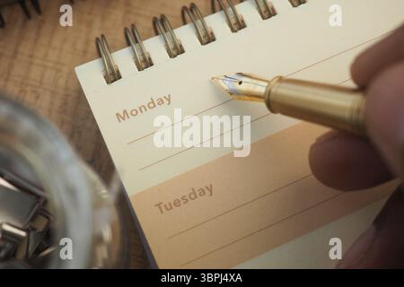 Writing plans in a notebook on a Wednesday afternoon Stock Photo - Alamy