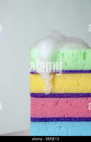 Colored sponges for washing dishes. Blue background Stock Photo - Alamy