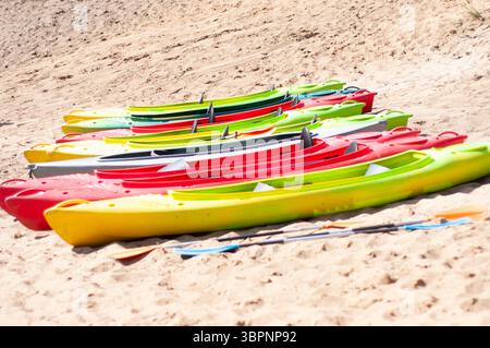 multi-colored canoes on the sand Stock Photo - Alamy