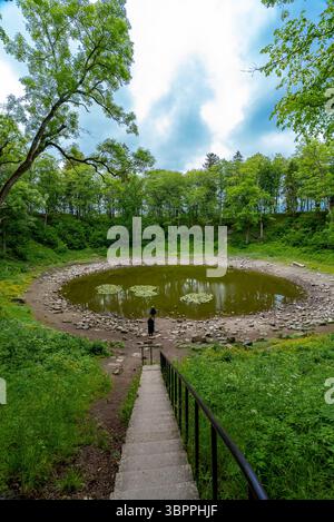 Scenic meteorite crater lake Kaali surrounded by forested terrain Stock ...
