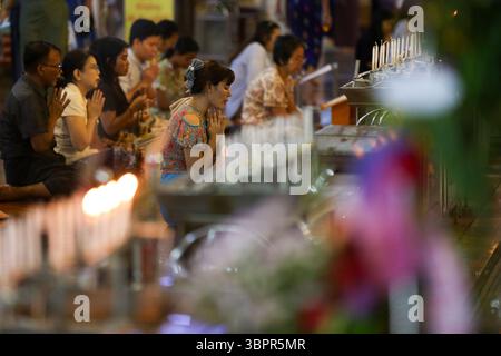 Yangon, Myanmar. 9th July, 2025. People light candles during ...
