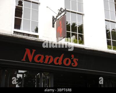 Nando’s, chicken Corporate logo signs in York City centre in June 2025 ...