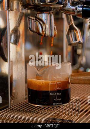 Pouring an espresso into a shot glass Stock Photo - Alamy